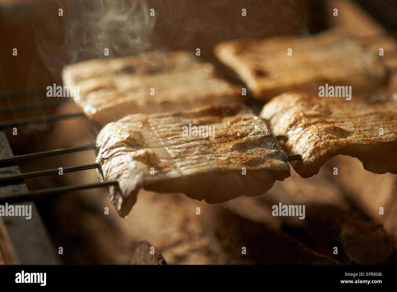 Skewered fish slices on barbeque Stock Photo - Alamy