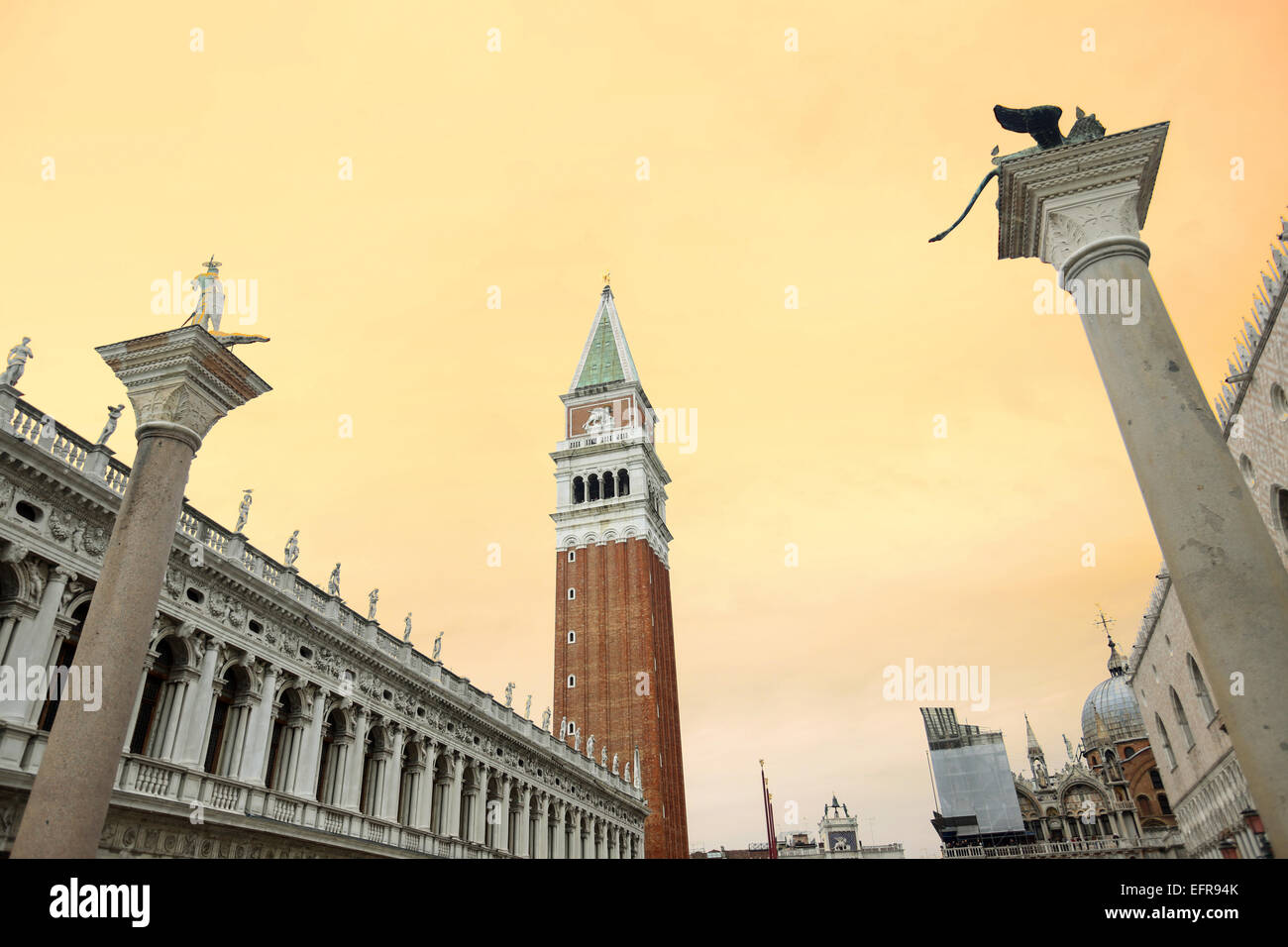 A low angle view of San Marco bell tower and the columns of San Marco and San Todaro in Venice ...