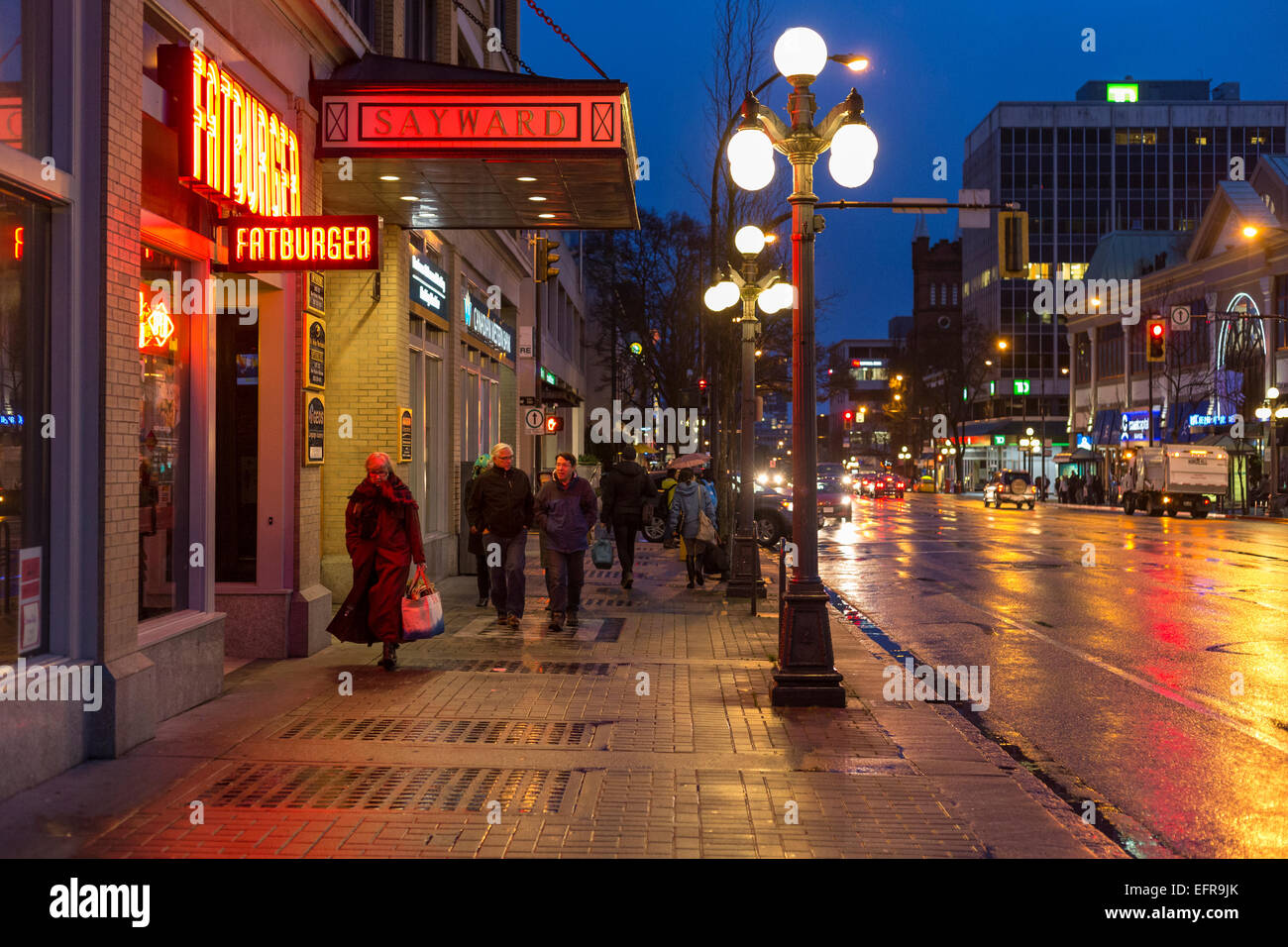 People Walking On The Street At Night