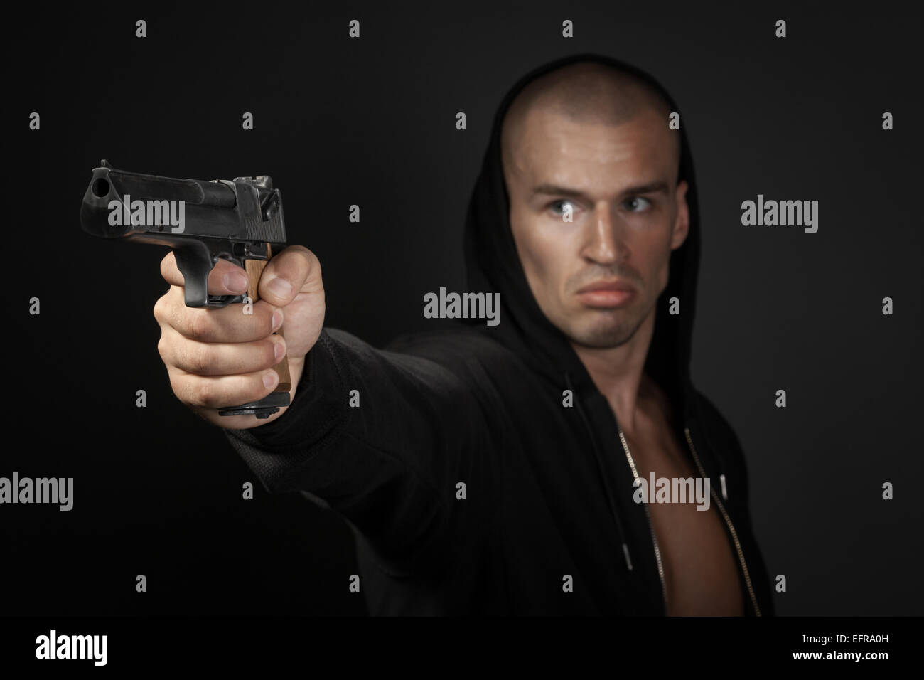 man shooting gun isolated on gray background. focus on gun Stock Photo ...