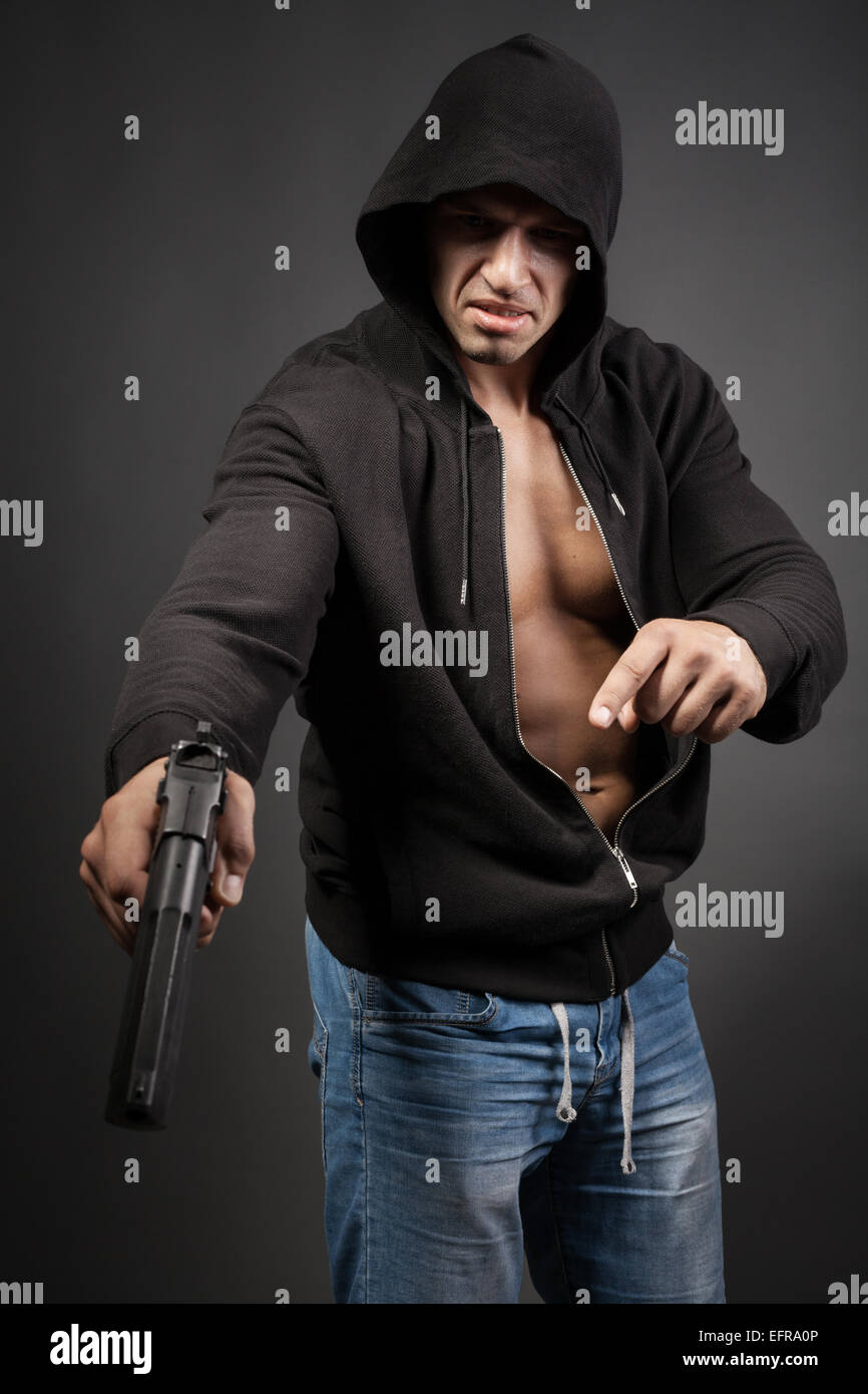 man shooting gun isolated on gray background Stock Photo - Alamy