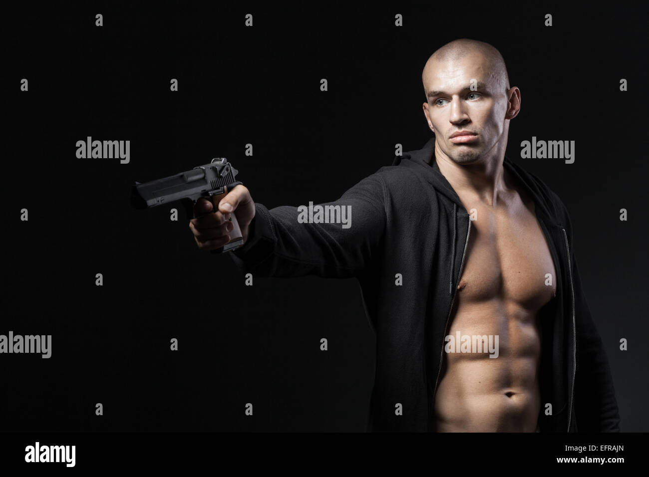 man shooting gun isolated on black background Stock Photo - Alamy