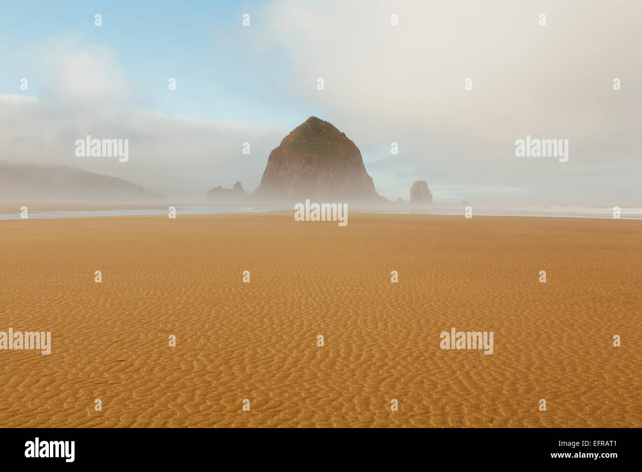 Lifting fog over Haystack Rock and Cannon Beach at dusk Stock Photo - Alamy