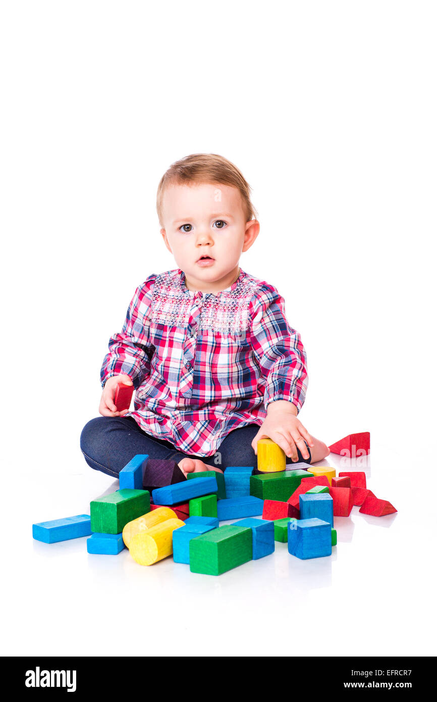 Beautiful baby building a castle with cubes isolated on white Stock ...