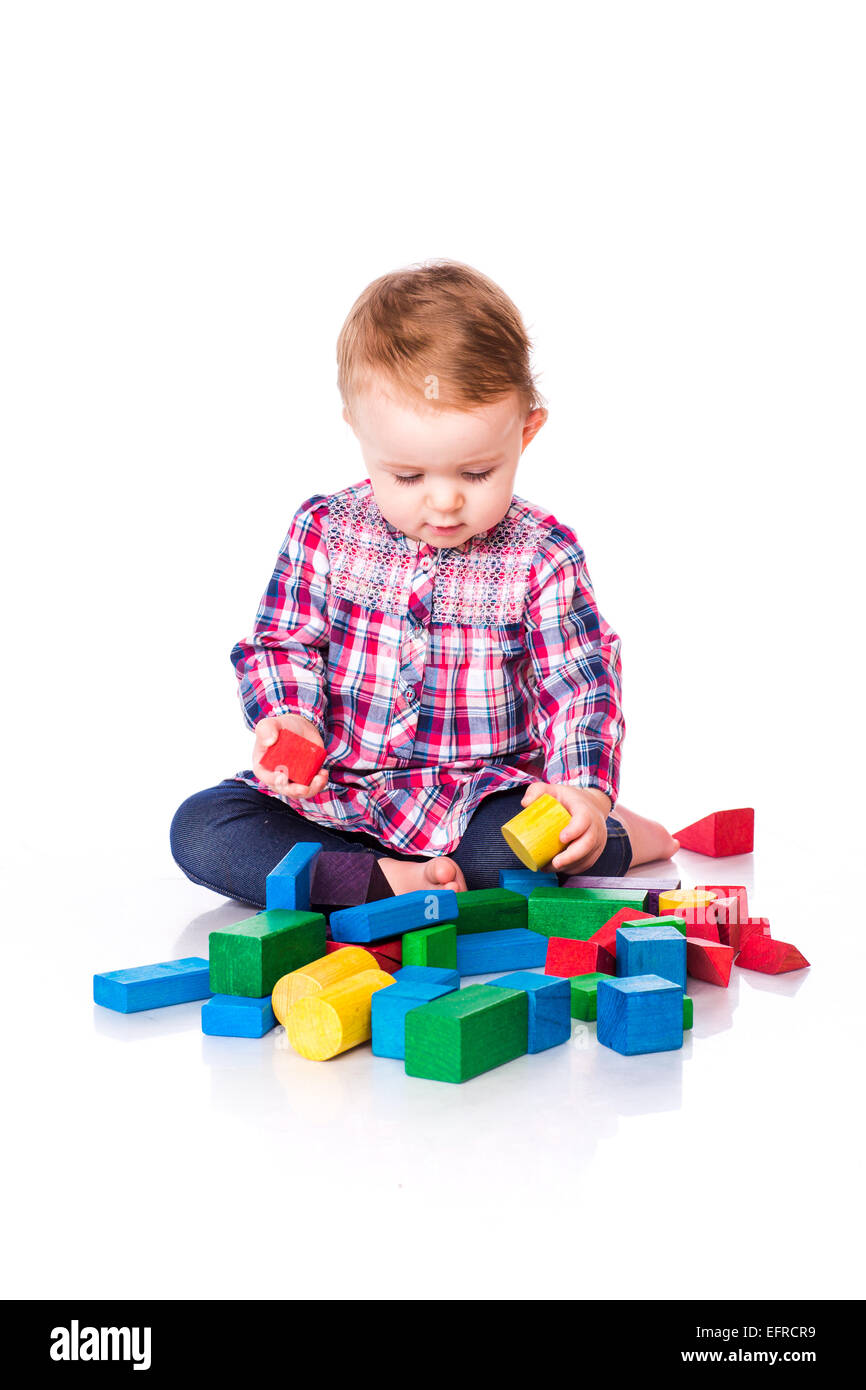 Beautiful baby building a castle with cubes isolated on white Stock ...