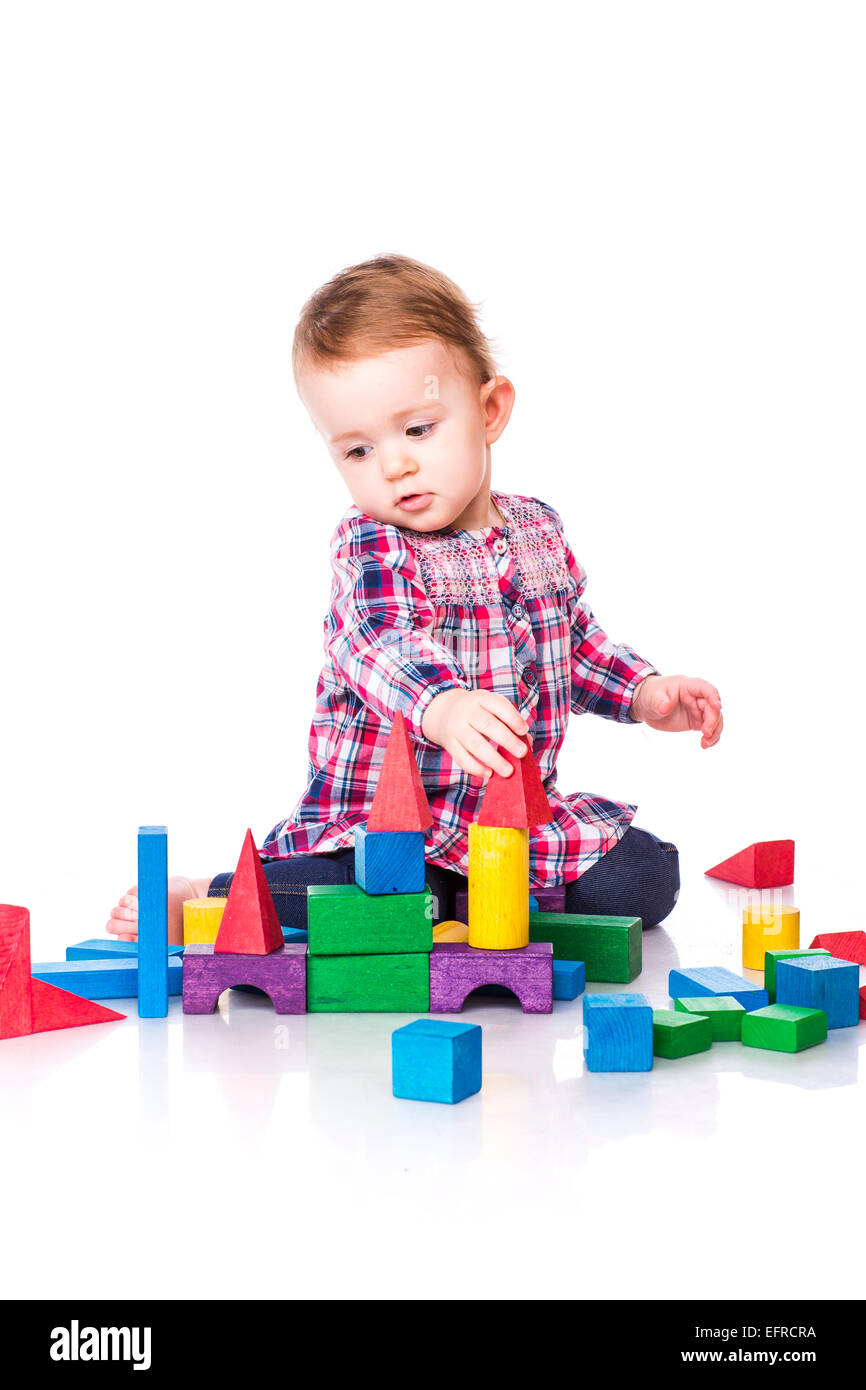Beautiful baby building a castle with cubes isolated on white Stock ...