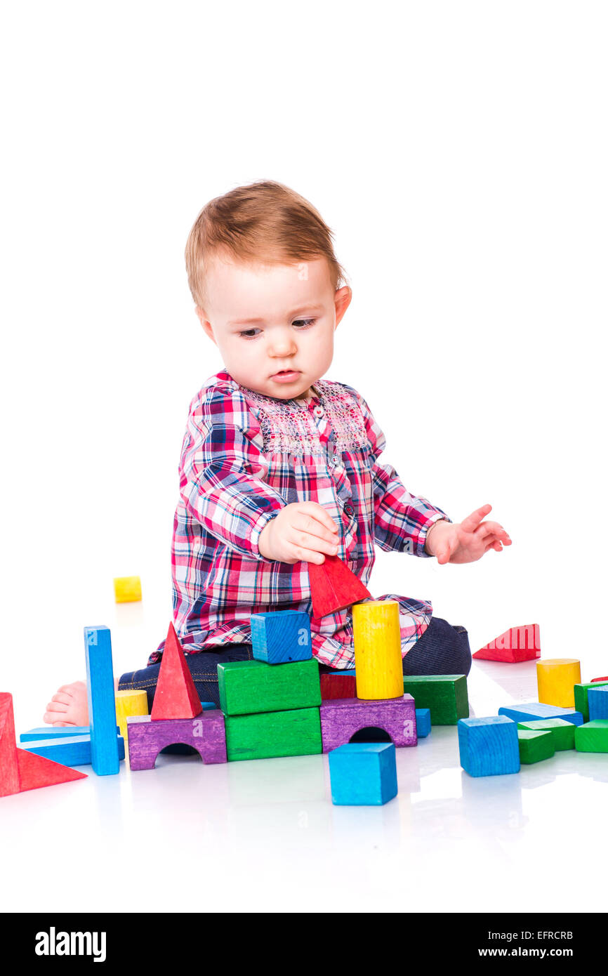 Beautiful baby building a castle with cubes isolated on white Stock ...