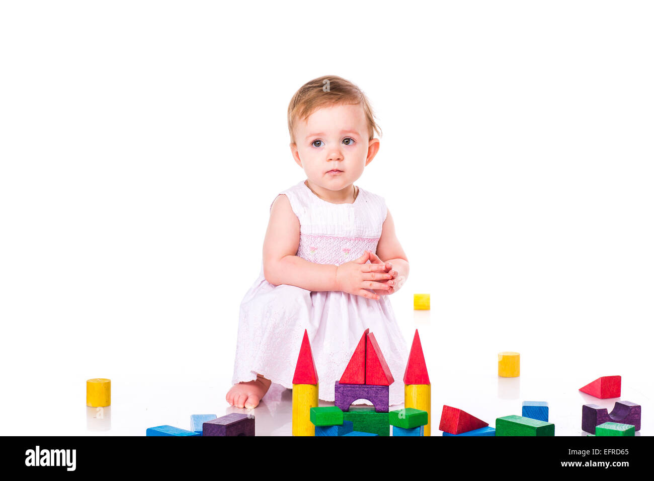 Beautiful baby building a castle with cubes isolated on white Stock ...