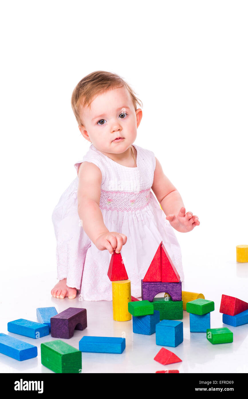 Beautiful baby building a castle with cubes isolated on white Stock ...