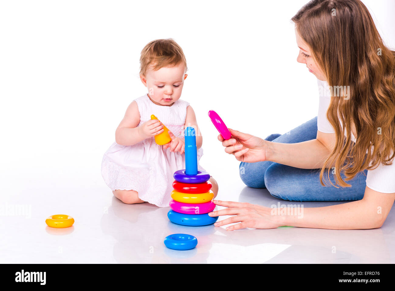 Beautiful baby with mother playing with stacking rings isolated on ...