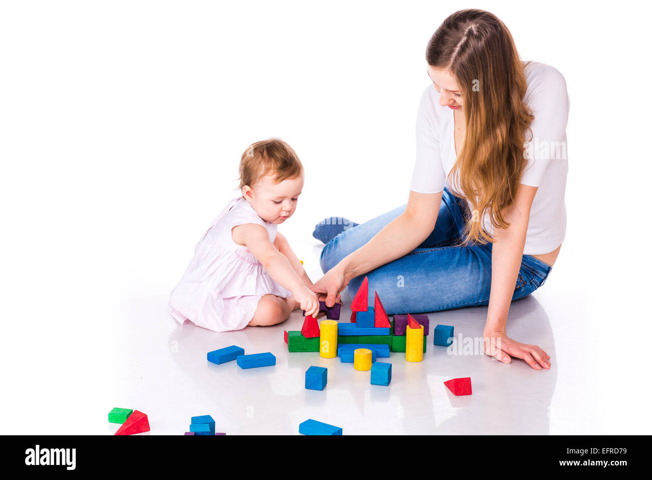Beautiful baby with mother building a castle with cubes isolated on ...