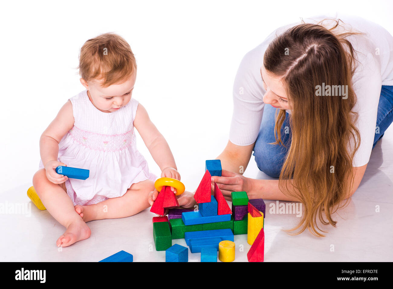 Beautiful baby with mother building a castle with cubes isolated on ...