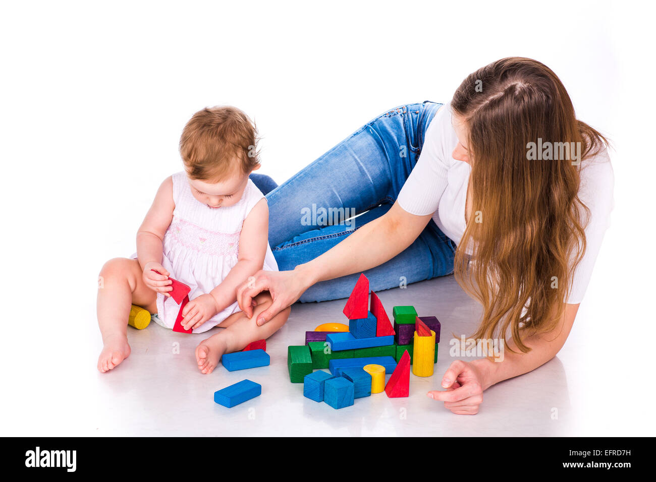 Beautiful baby with mother building a castle with cubes isolated on ...