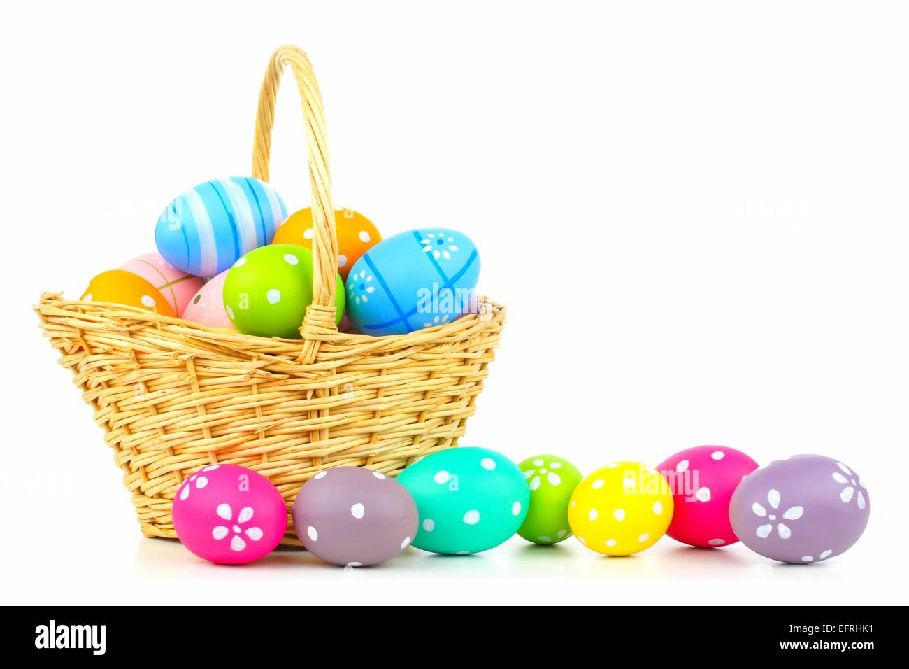 Easter basket filled with colorful eggs on a white background Stock ...