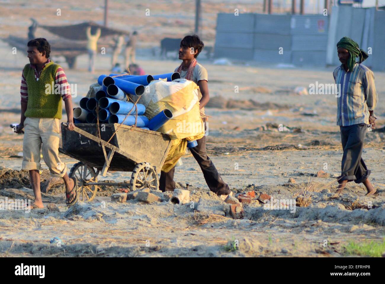 Workers collect water pipes after the completion of Magh mela fair ...