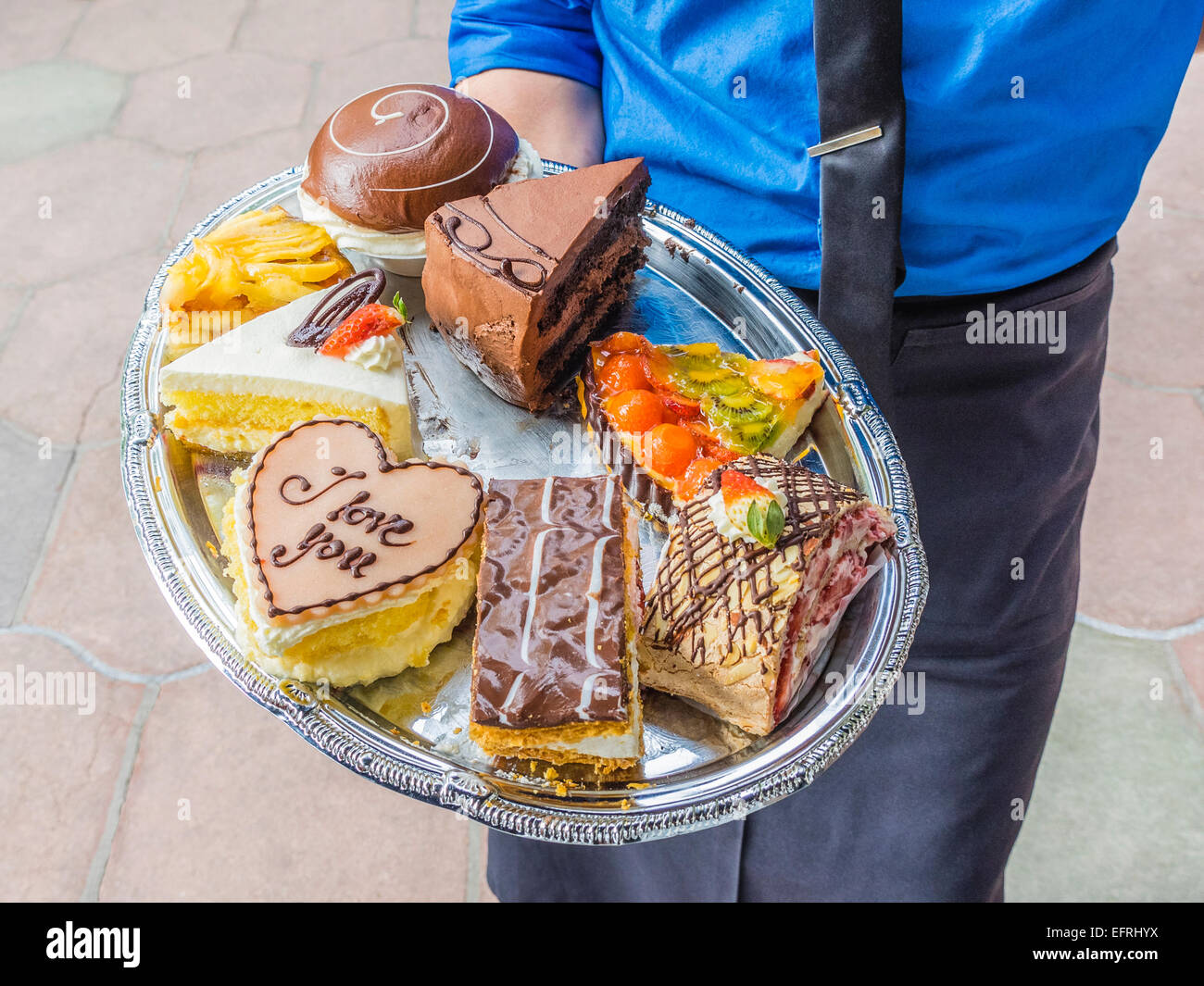 An elegant dessert tray presented on a silver platter at a patio ...
