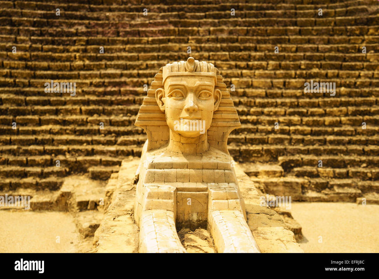sphinx model close-up with pyramid background Stock Photo - Alamy