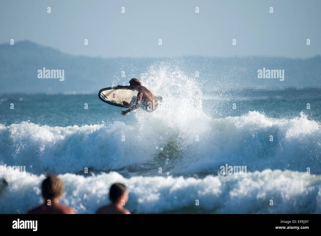 Young man surfing in Bali, Indonesia Stock Photo - Alamy