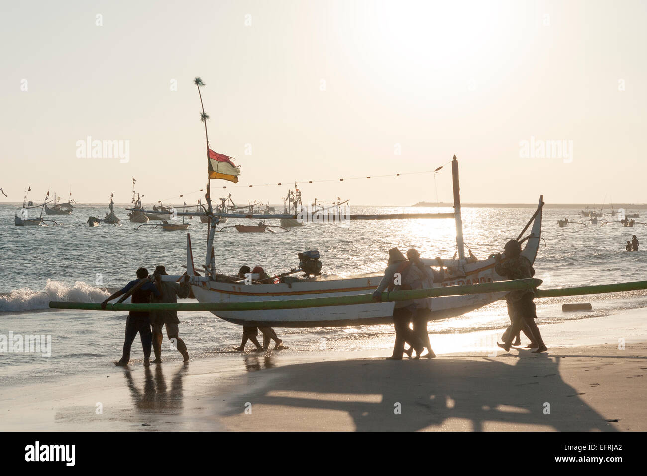 Fishermen carrying boat in Bali, Indonesia Stock Photo - Alamy