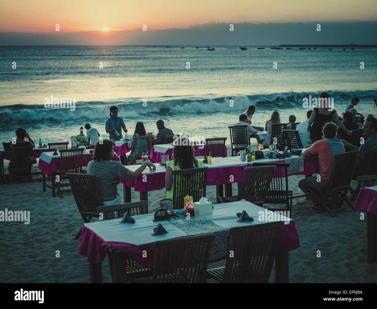 People enjoying sunset dinner in Bali, Indonesia Stock Photo - Alamy