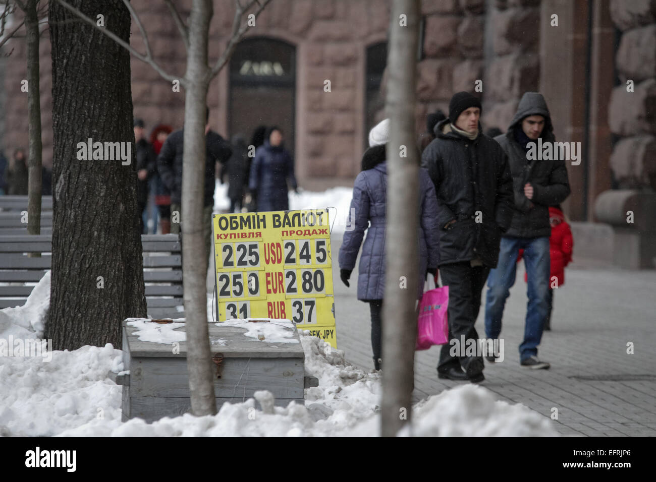 People passes the currencies exchange rate plate downtown Kiev. Ukraine ...