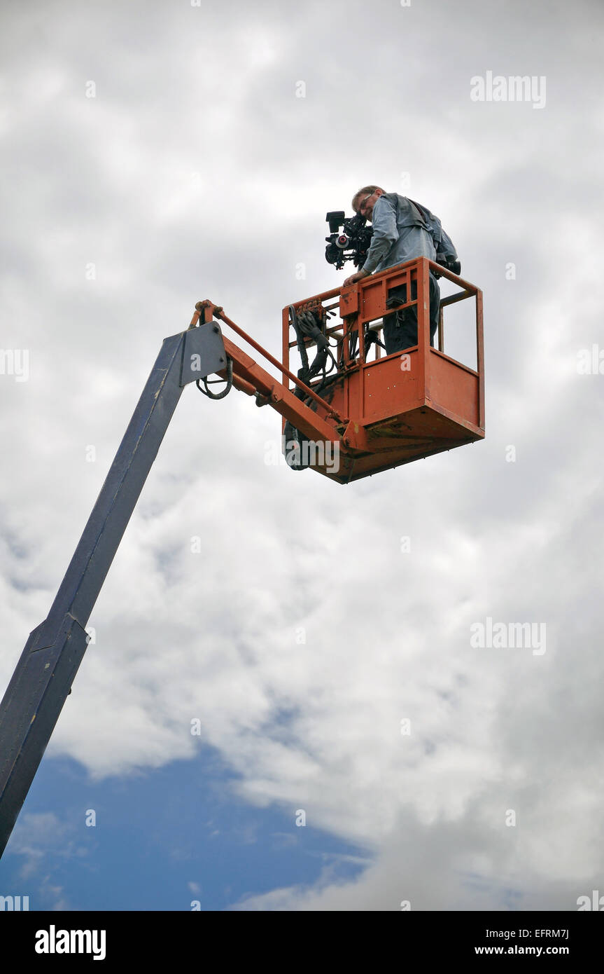 Cameraman using a cherry picker on location Stock Photo - Alamy
