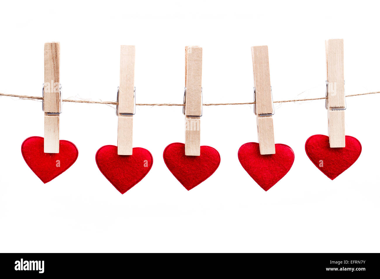 Red fabric heart hanging on the clothesline, Isolated on white ...