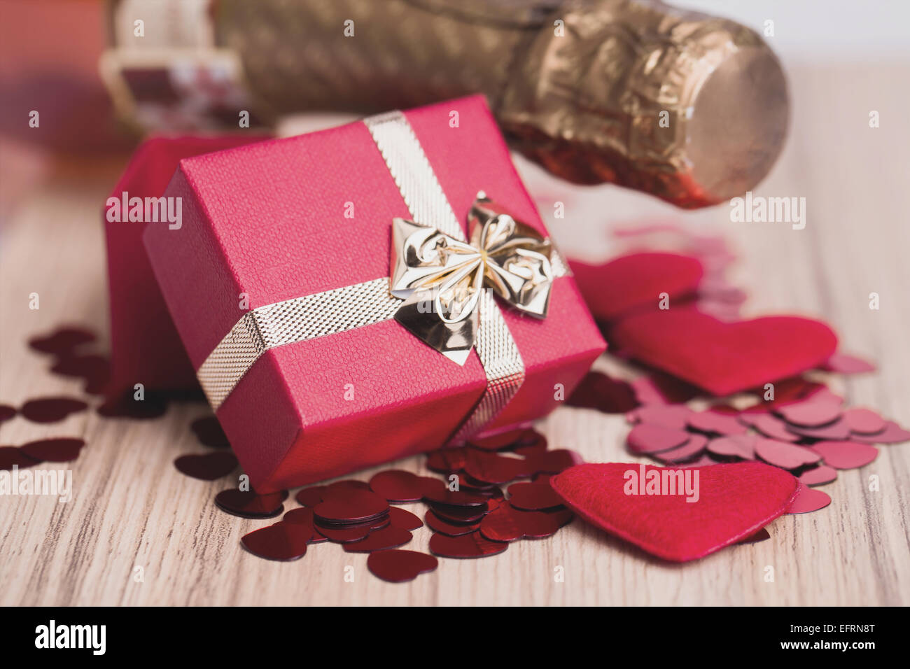 Valentines day: bottle of vine, red hearts and small present Stock ...