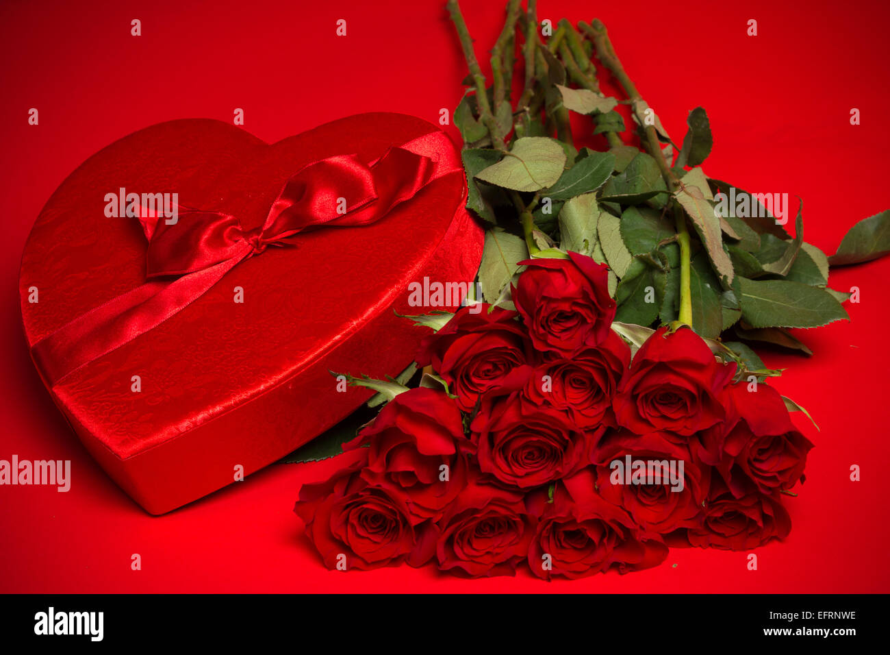 A Valentine Candy Box and red Roses on Red Background Stock Photo - Alamy