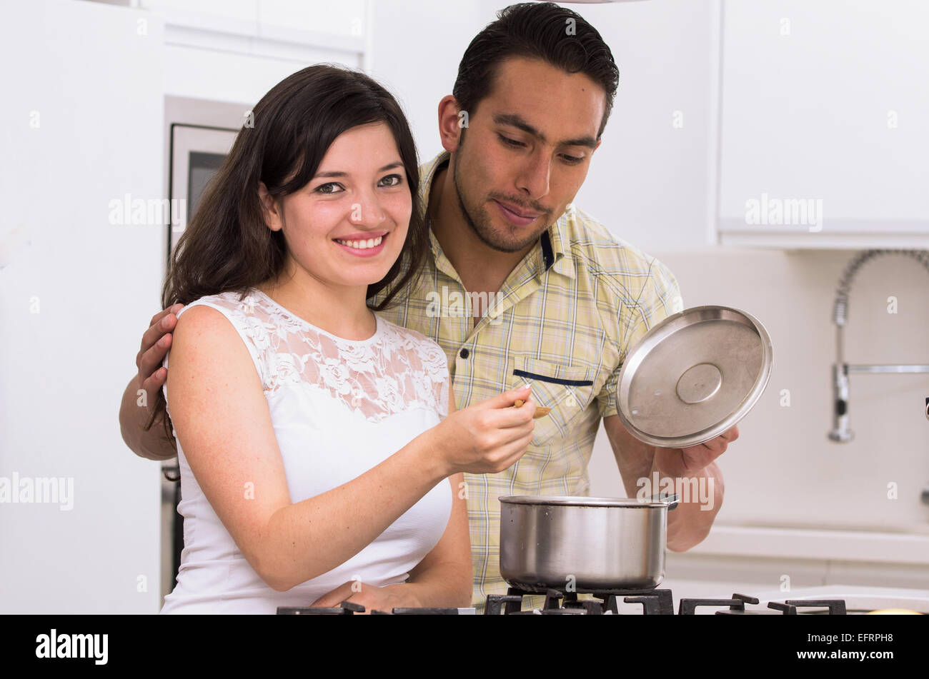 Two friends prepare meal together hi-res stock photography and images ...