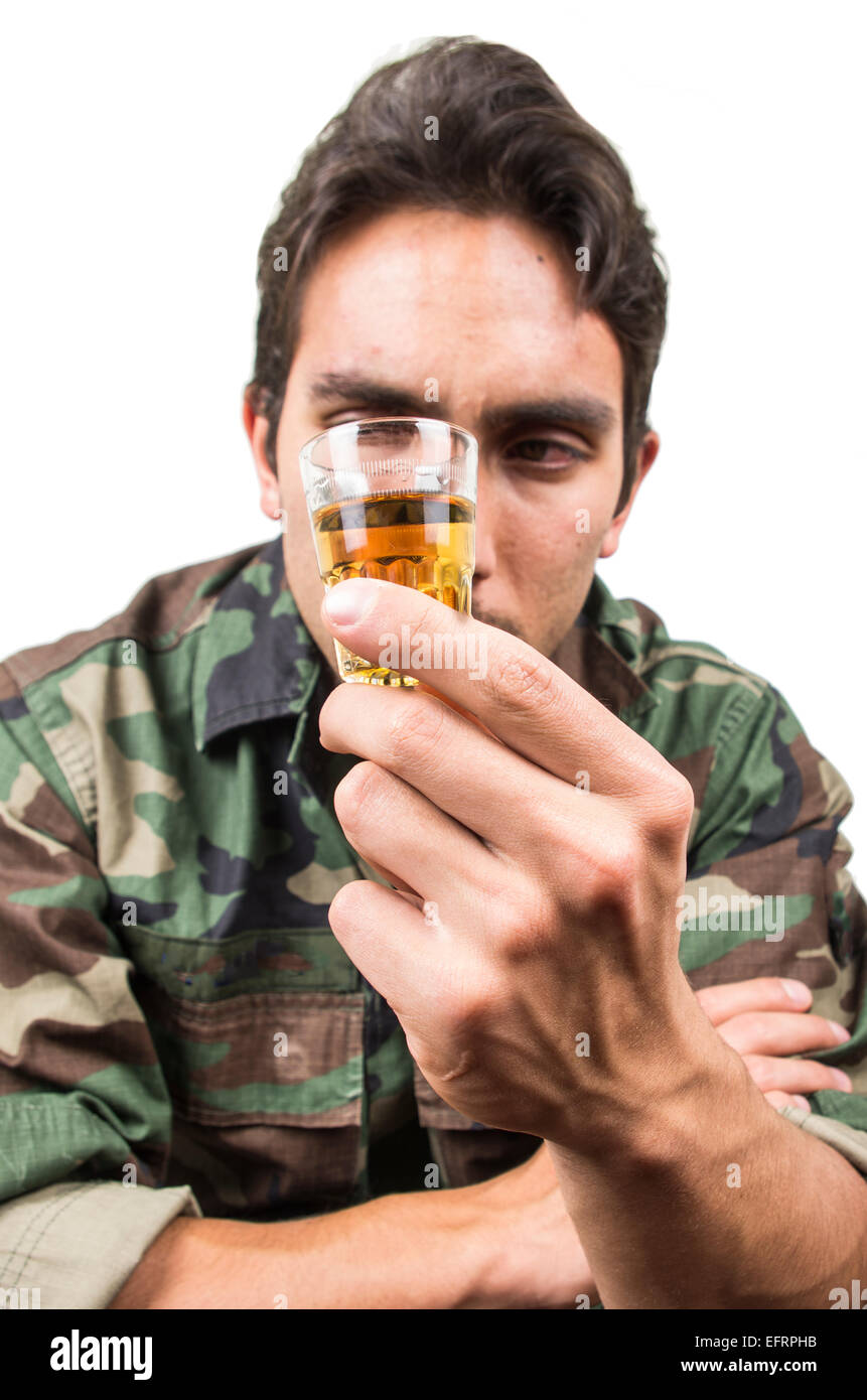 distraught military soldier veteran ptsd drinking a shot of liquor ...