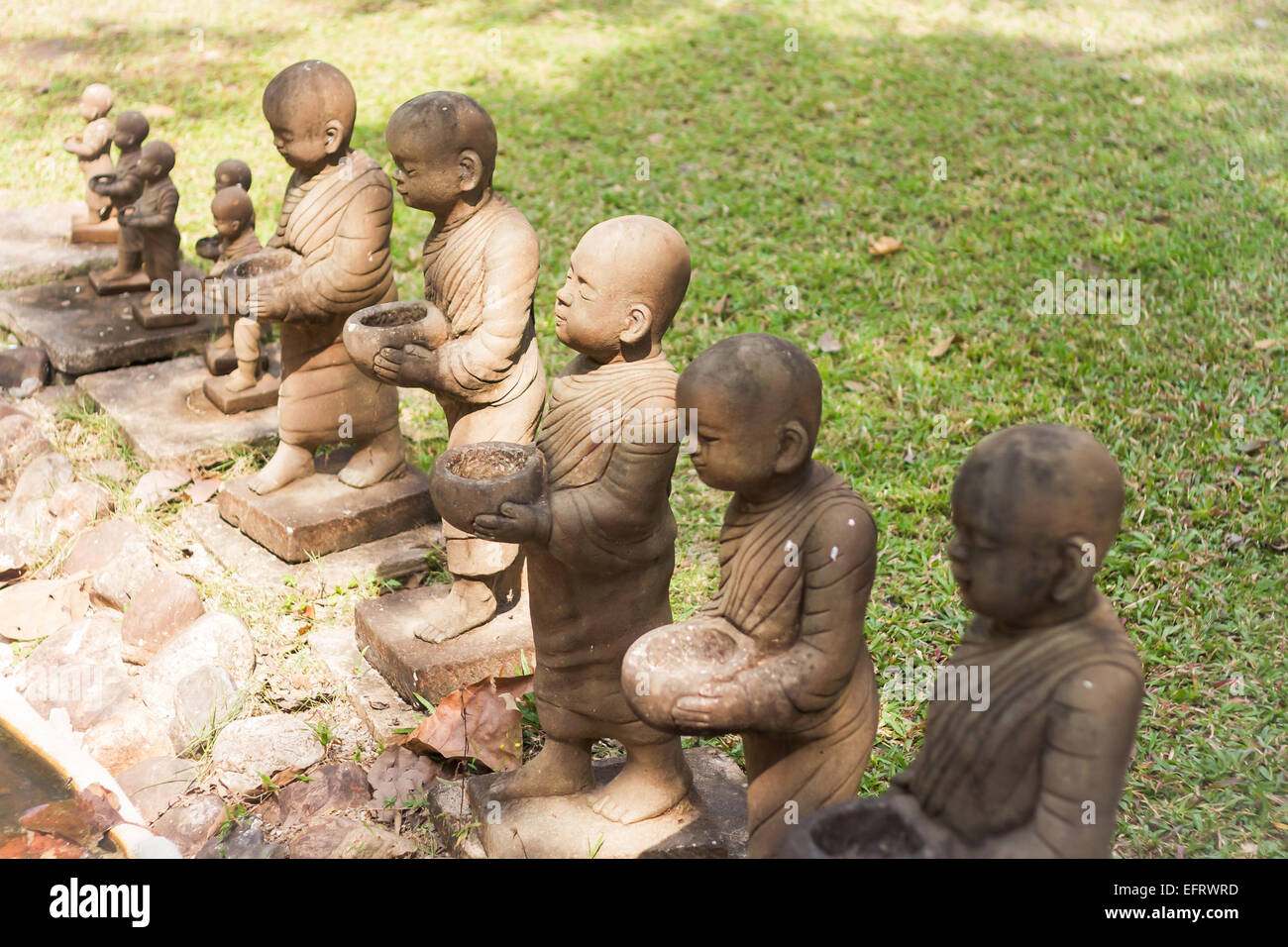 Little monk clay doll decorated in garden, stock photo Stock Photo - Alamy