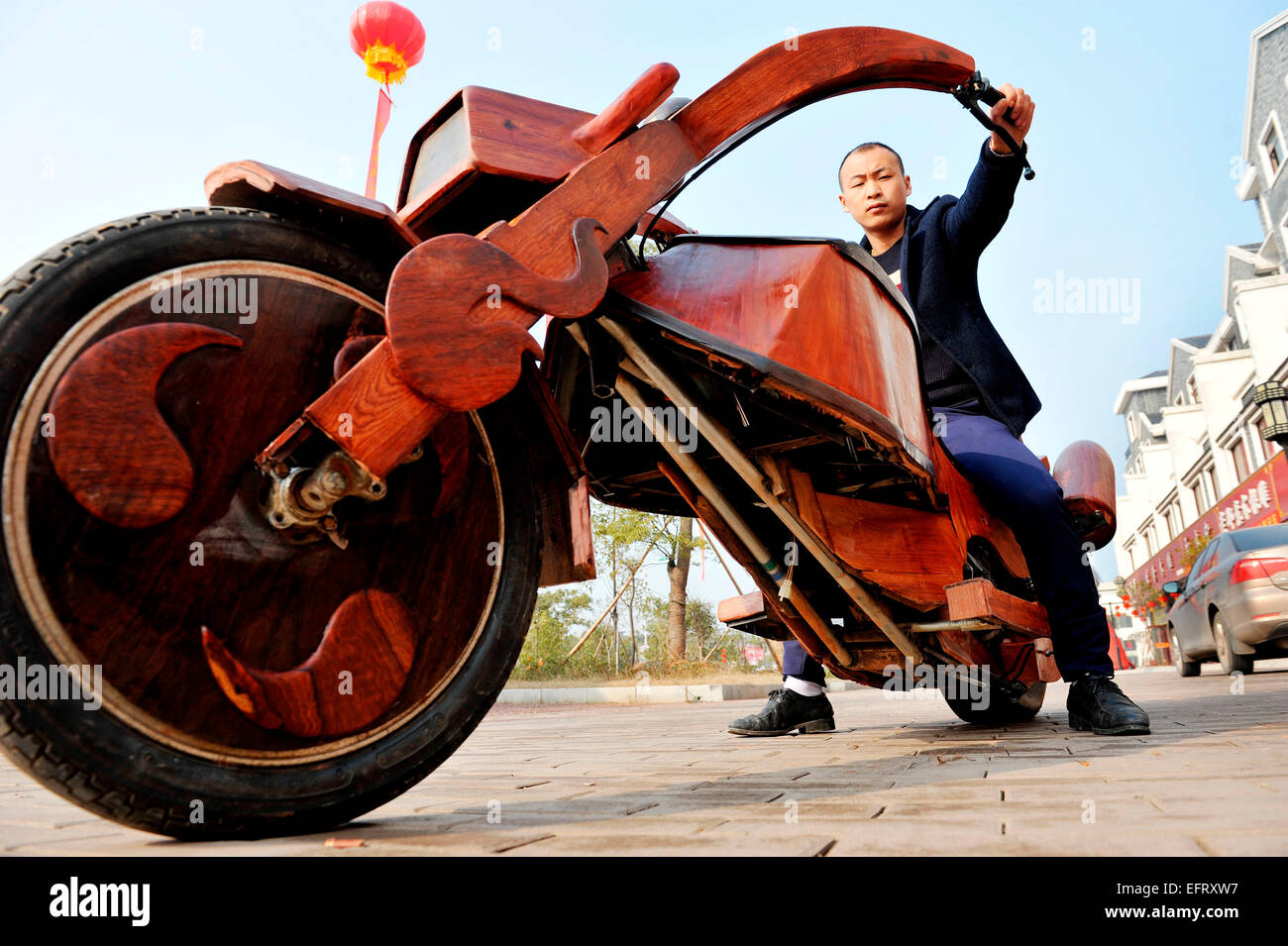 Guangfeng, China. 09th Feb, 2015. A peasant makes a wood motobike by ...
