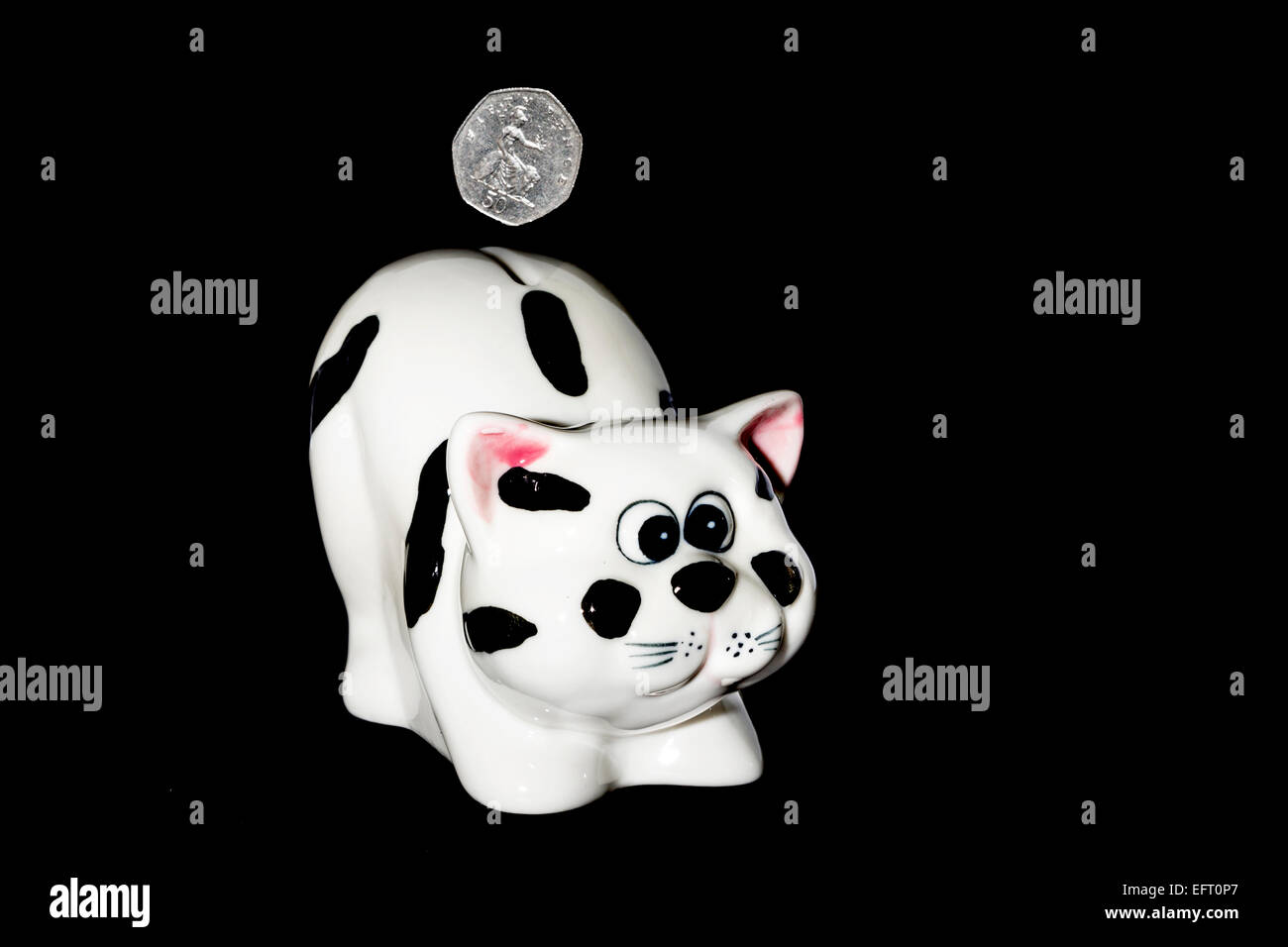 White savings bank similar to a piggy-bank but in the shape of a cat ...