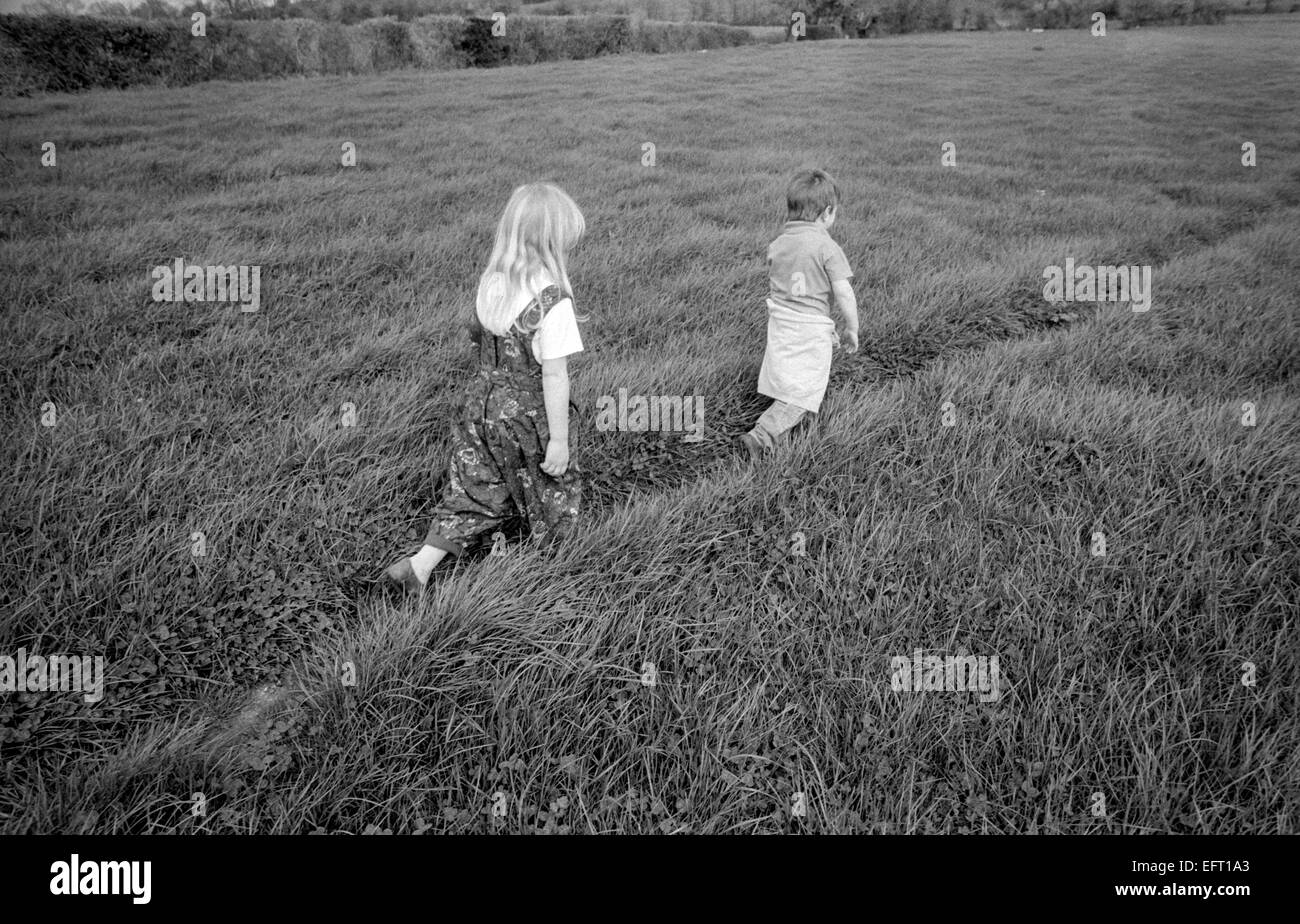 Two children run free in a field Stock Photo - Alamy