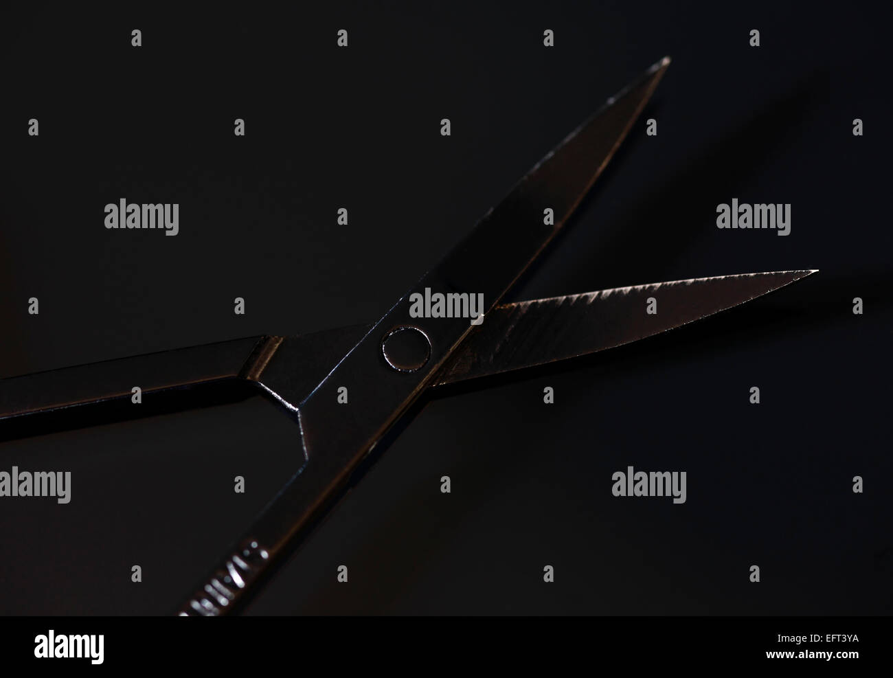 Black scissors on a dark background Stock Photo - Alamy