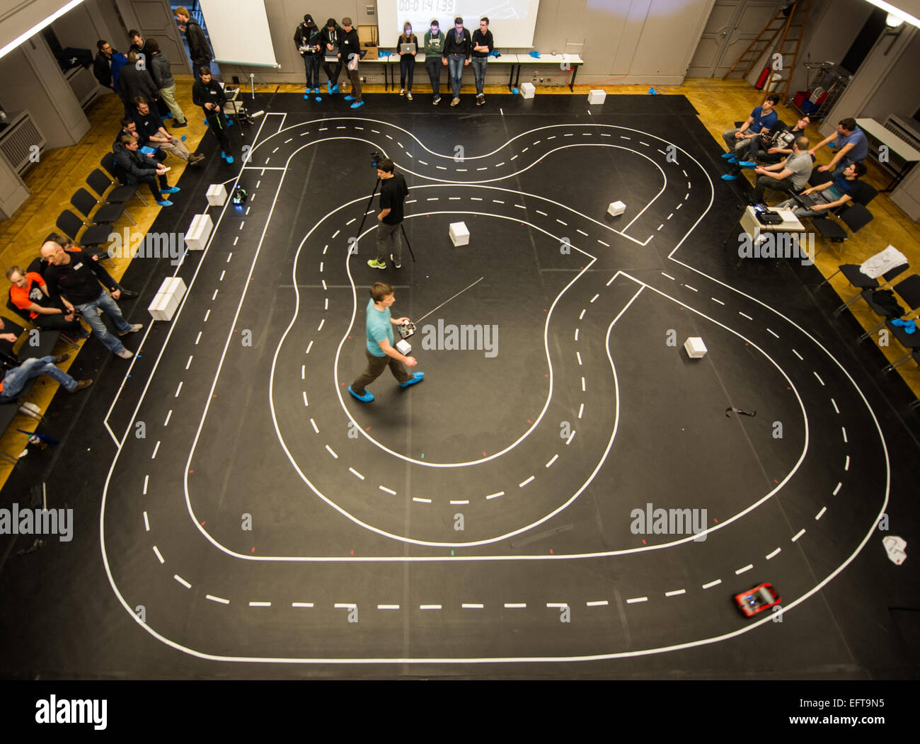 Participating students drive their miniature car models during a test ...
