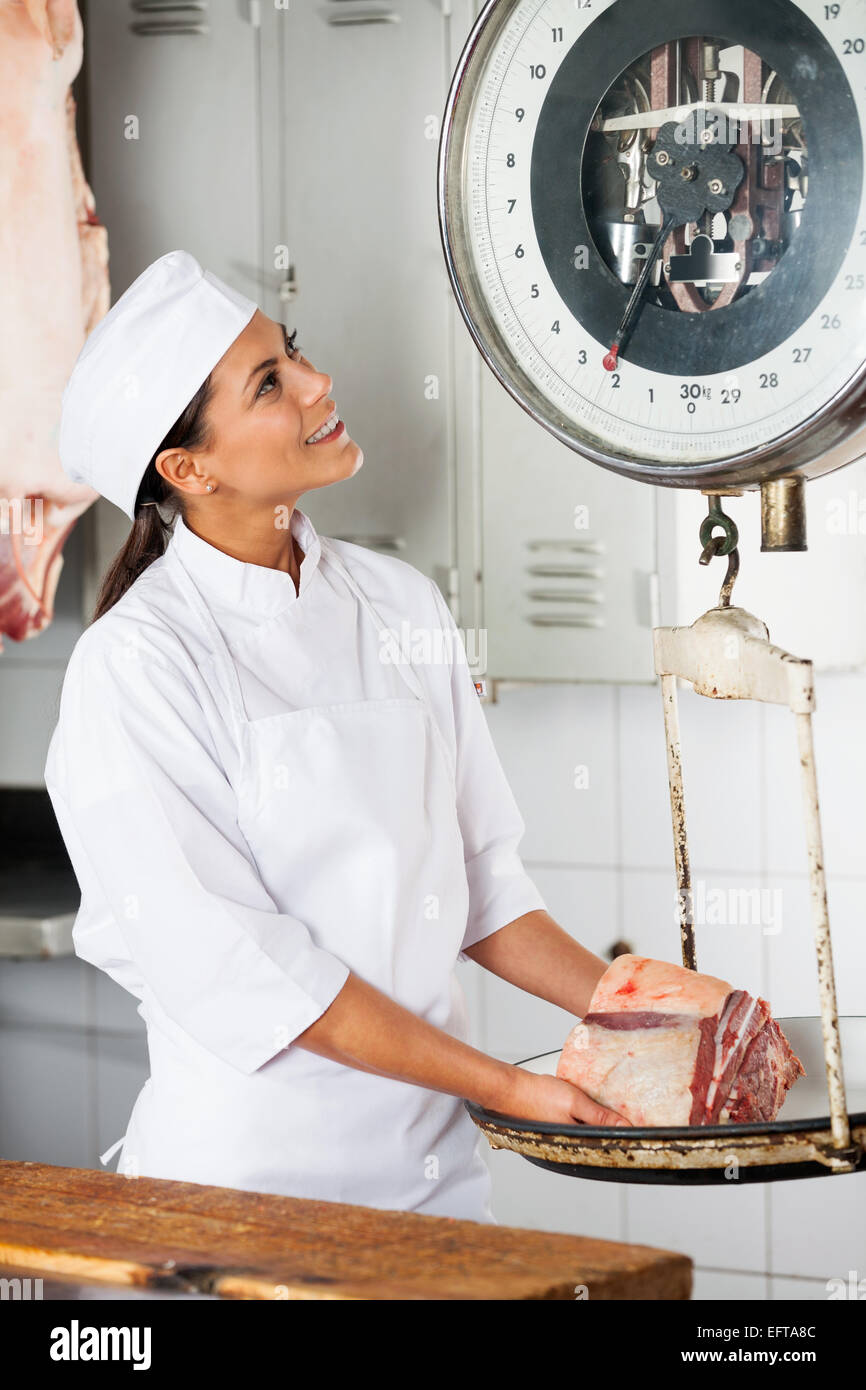 Butcher Weighing Meat On Scale Stock Photo - Alamy