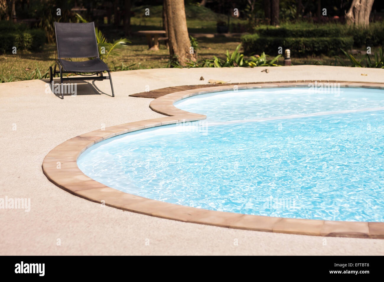 Swimming pool with beach chairs, stock photo Stock Photo - Alamy