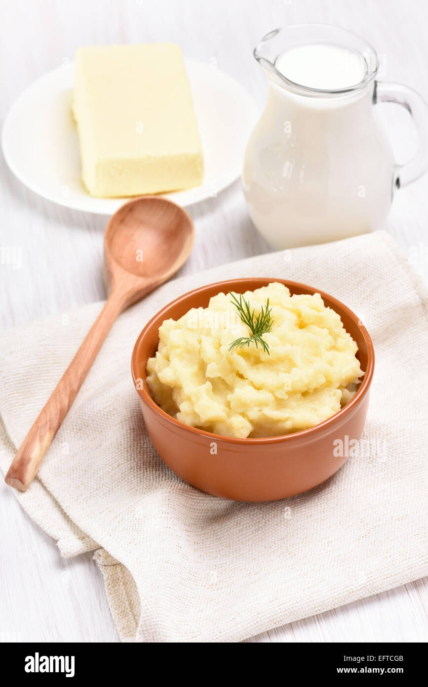 Mashed potato, jug of milk and butter on white table Stock Photo - Alamy