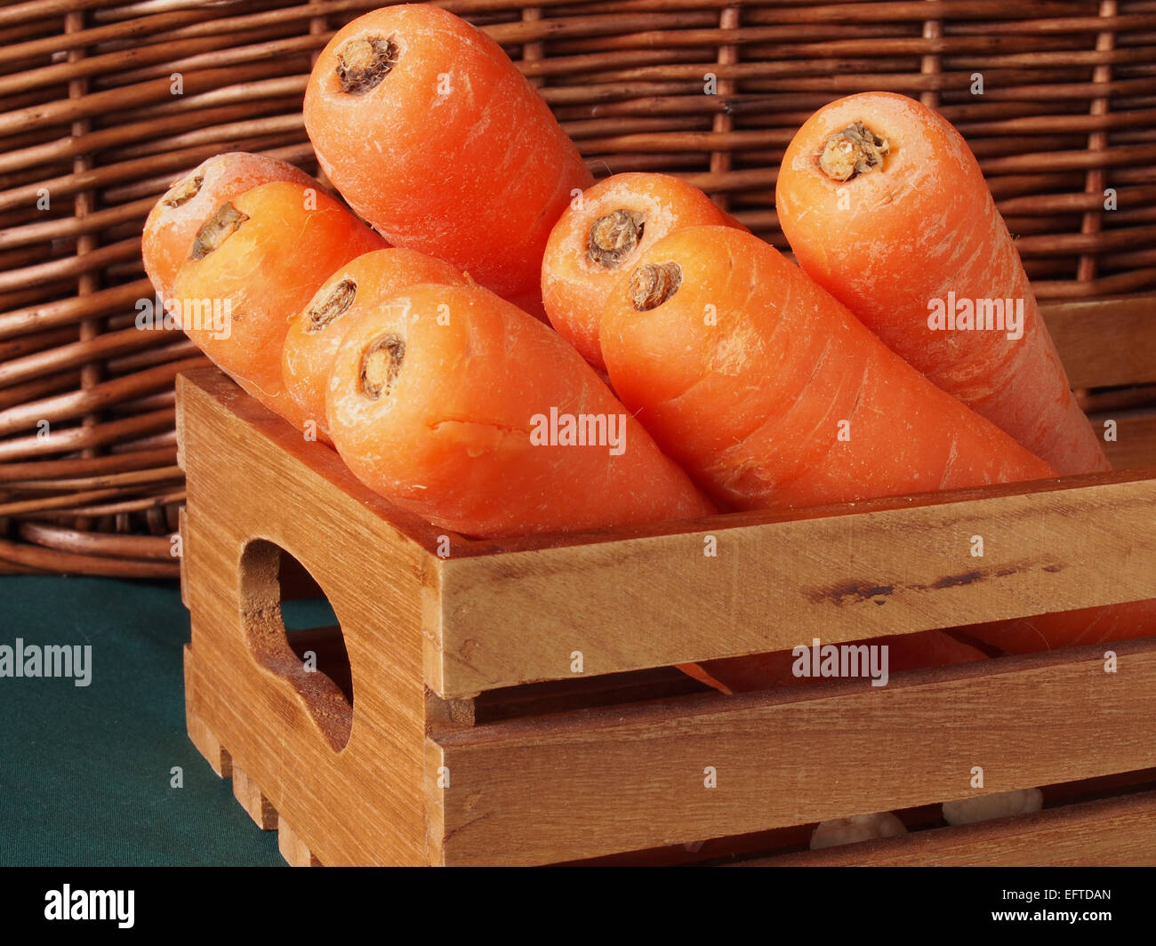 carrots grouped together in a wooden box for storage and transportation ...