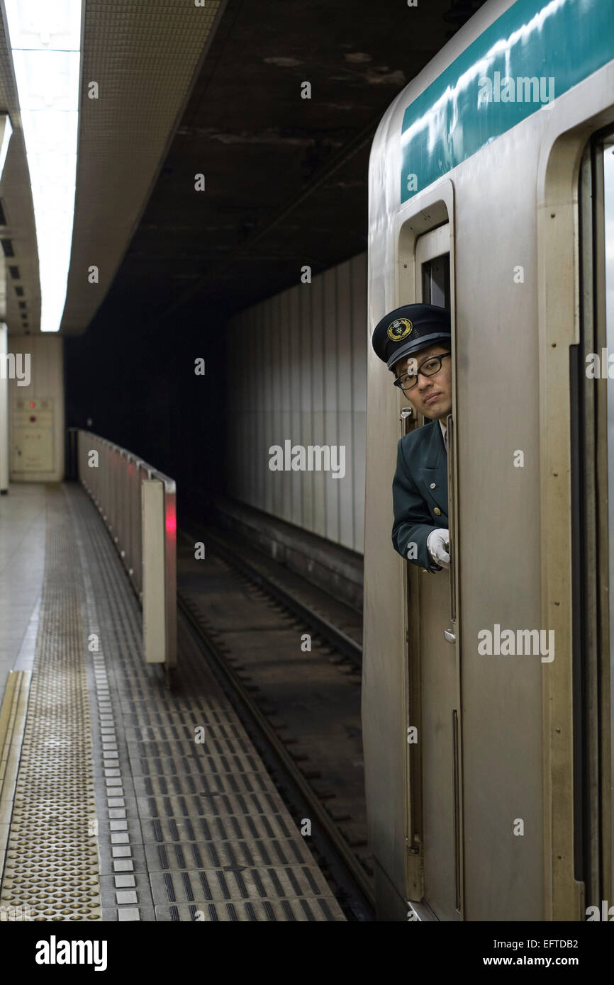 Subway train conductor looking down the platform from the train window ...