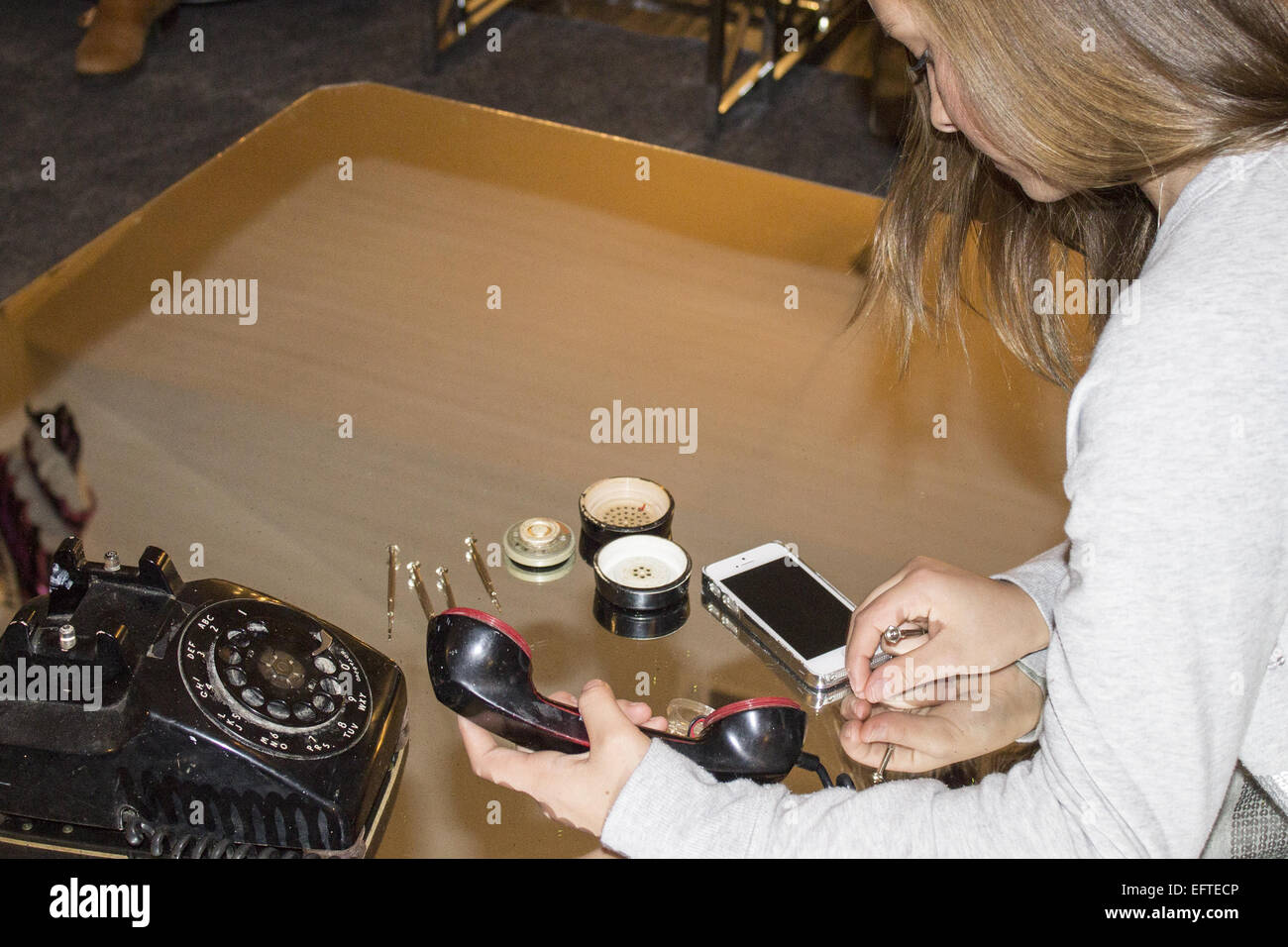 girl repairing a vintage rotary dial phone Stock Photo - Alamy