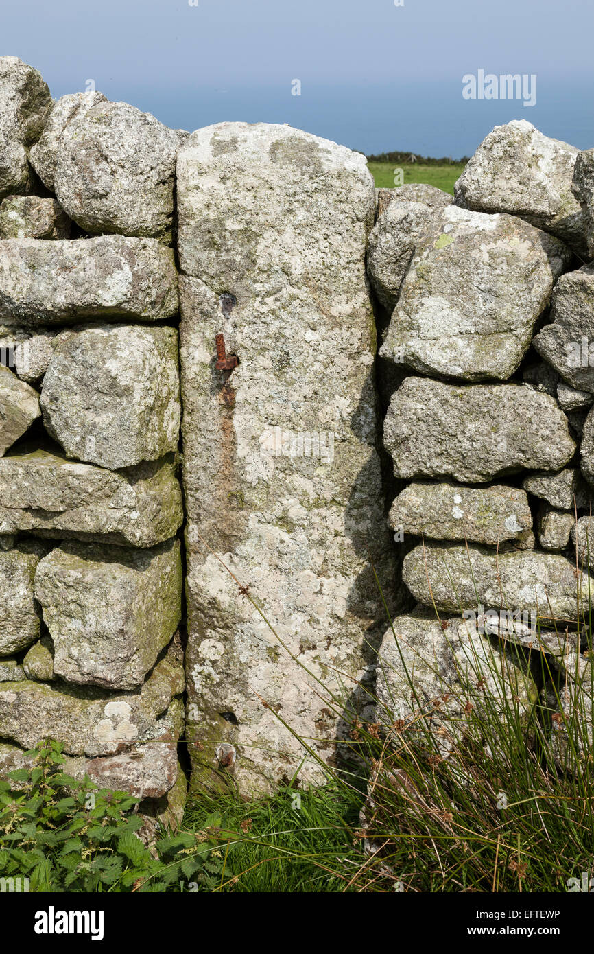 Stone gatepost incorporated into a dry stone wall on Lundy Island Stock ...