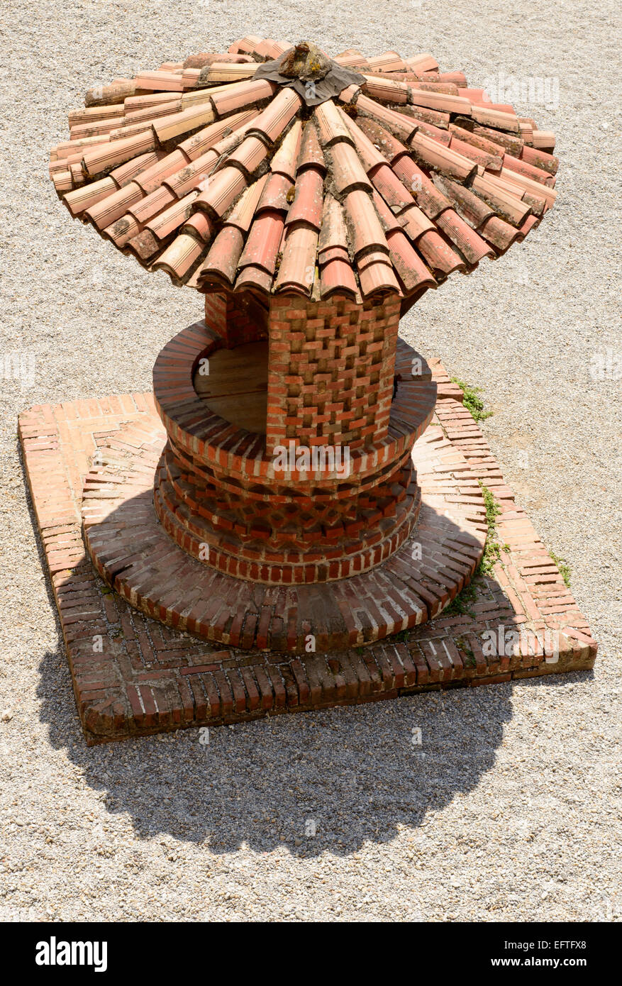 small round brick stucture and roof that covers the ancient well in ...