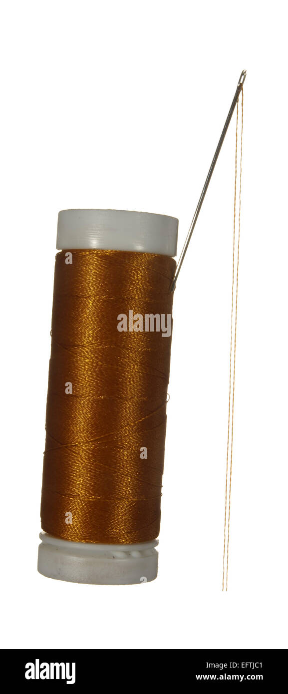 Spool of brown thread and needle isolated on white background Stock ...