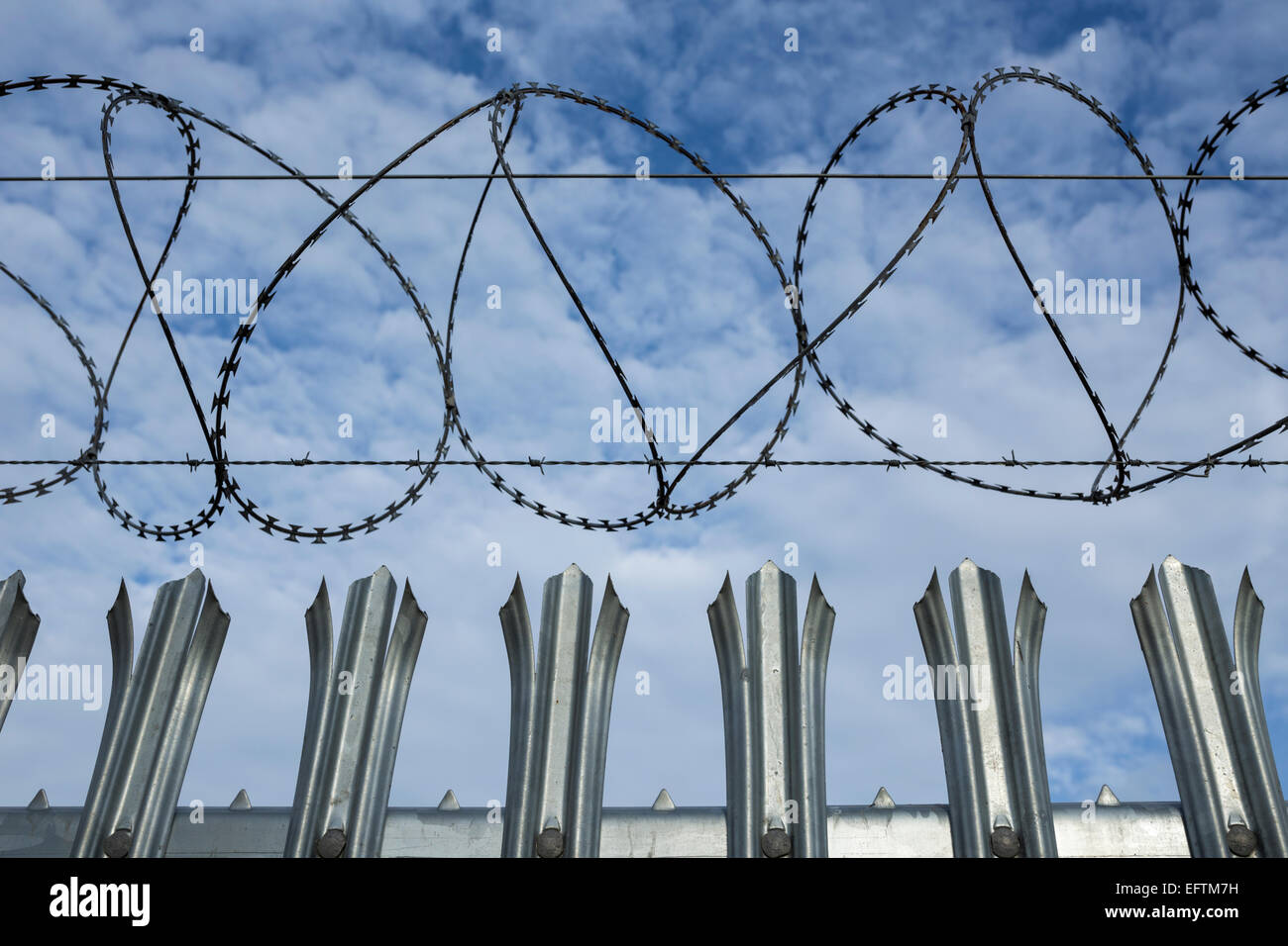 Steel razor wire perimeter fence Stock Photo - Alamy