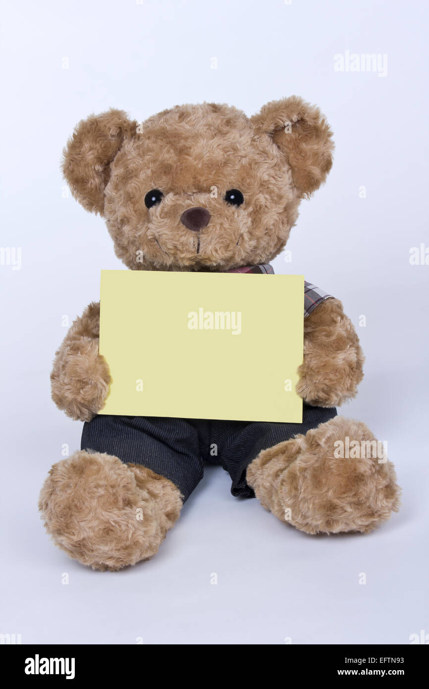 Teddy bear holding a sign Stock Photo - Alamy