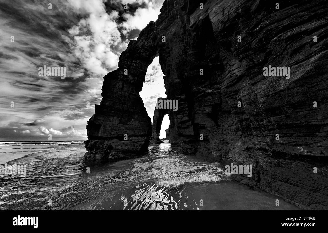 Spain, Galicia: Rock arcs at Cathedral´s beach in black and white ...