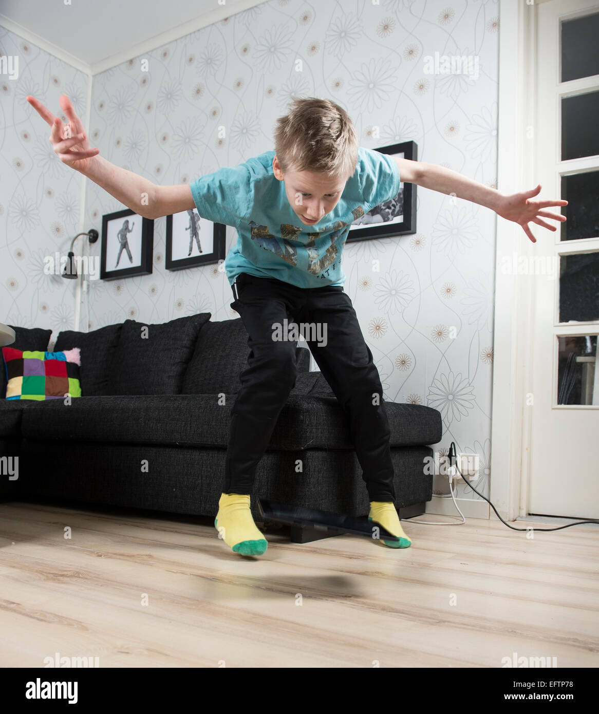 Young boy dropping a tablet on the floor Stock Photo - Alamy